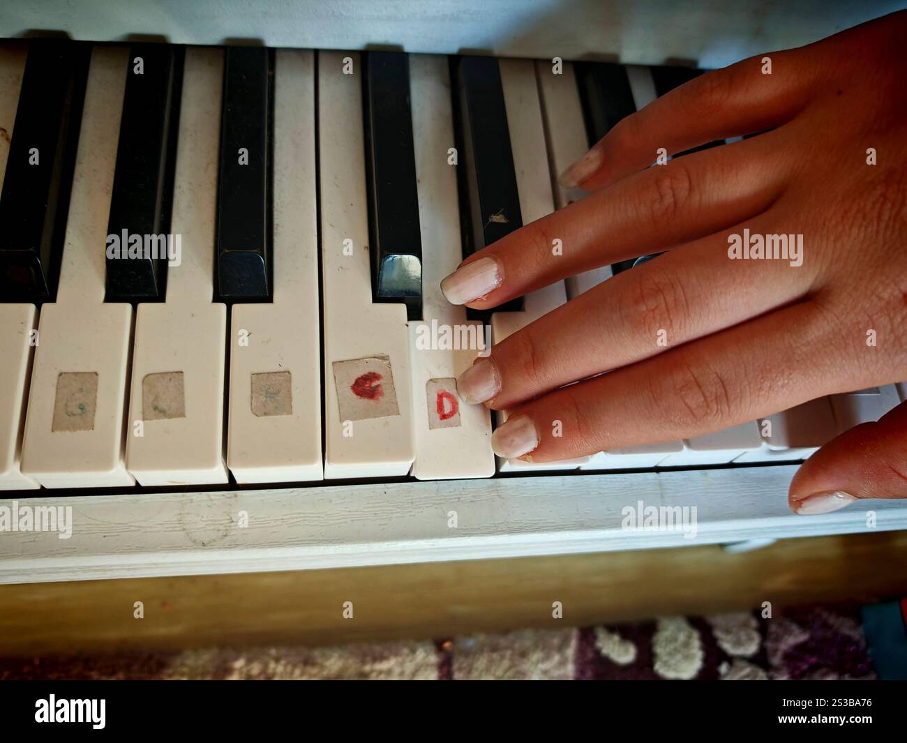 a piano, a stringed keyboard instrument for playing music pieces a ...