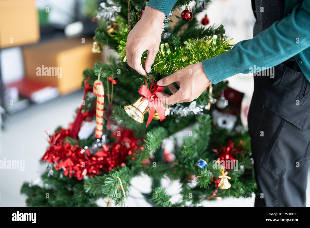 Happy hands Decorating Christmas tree for xmas holiday Stock Photo - Alamy