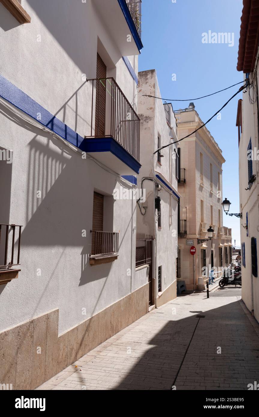 Sitges, a typical narrow street with waterwashed houses, Garraf Coast ...