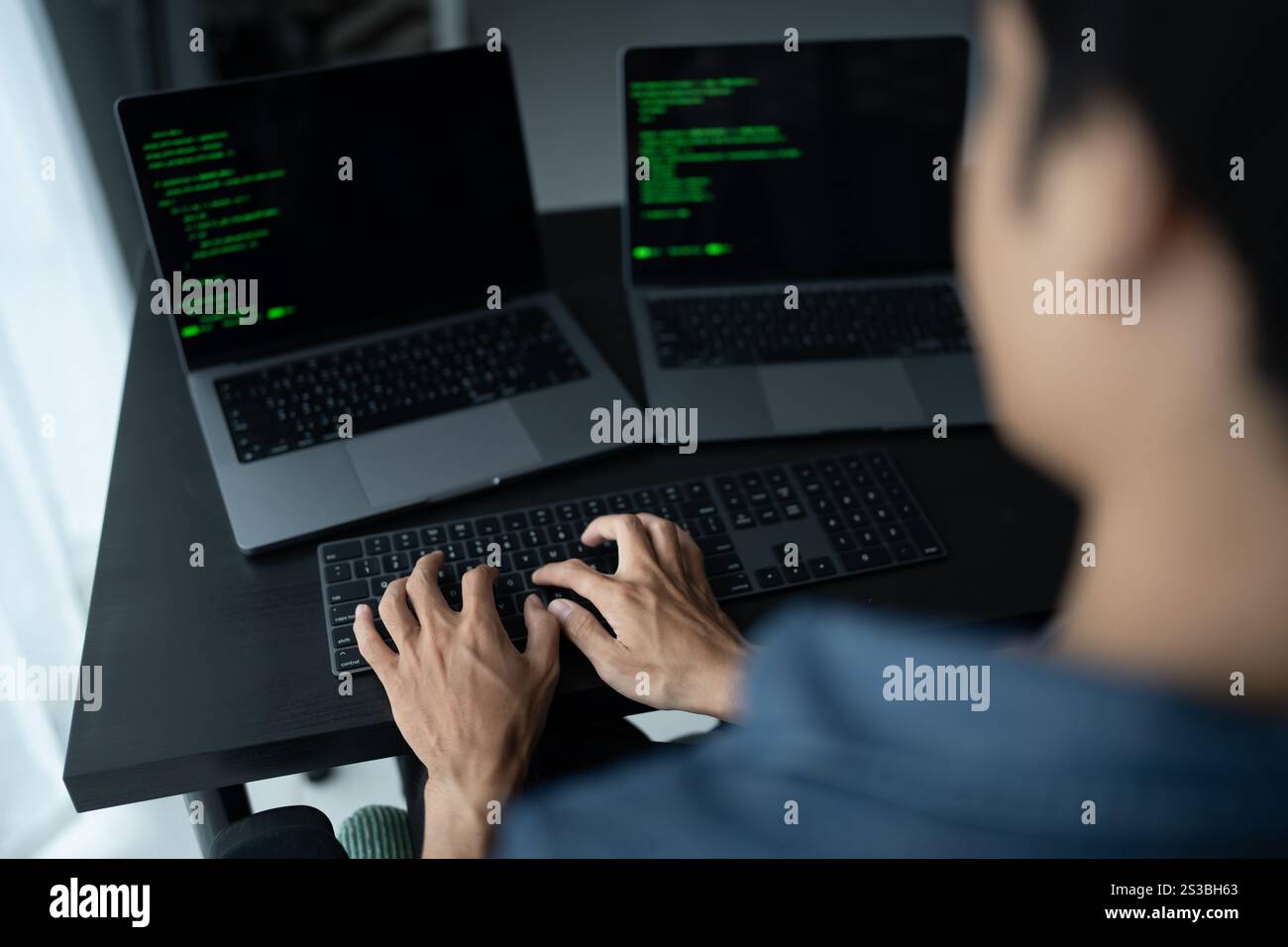 Asian Man Software Engineer Working On Computer At Office Desk For Writing Program Code It