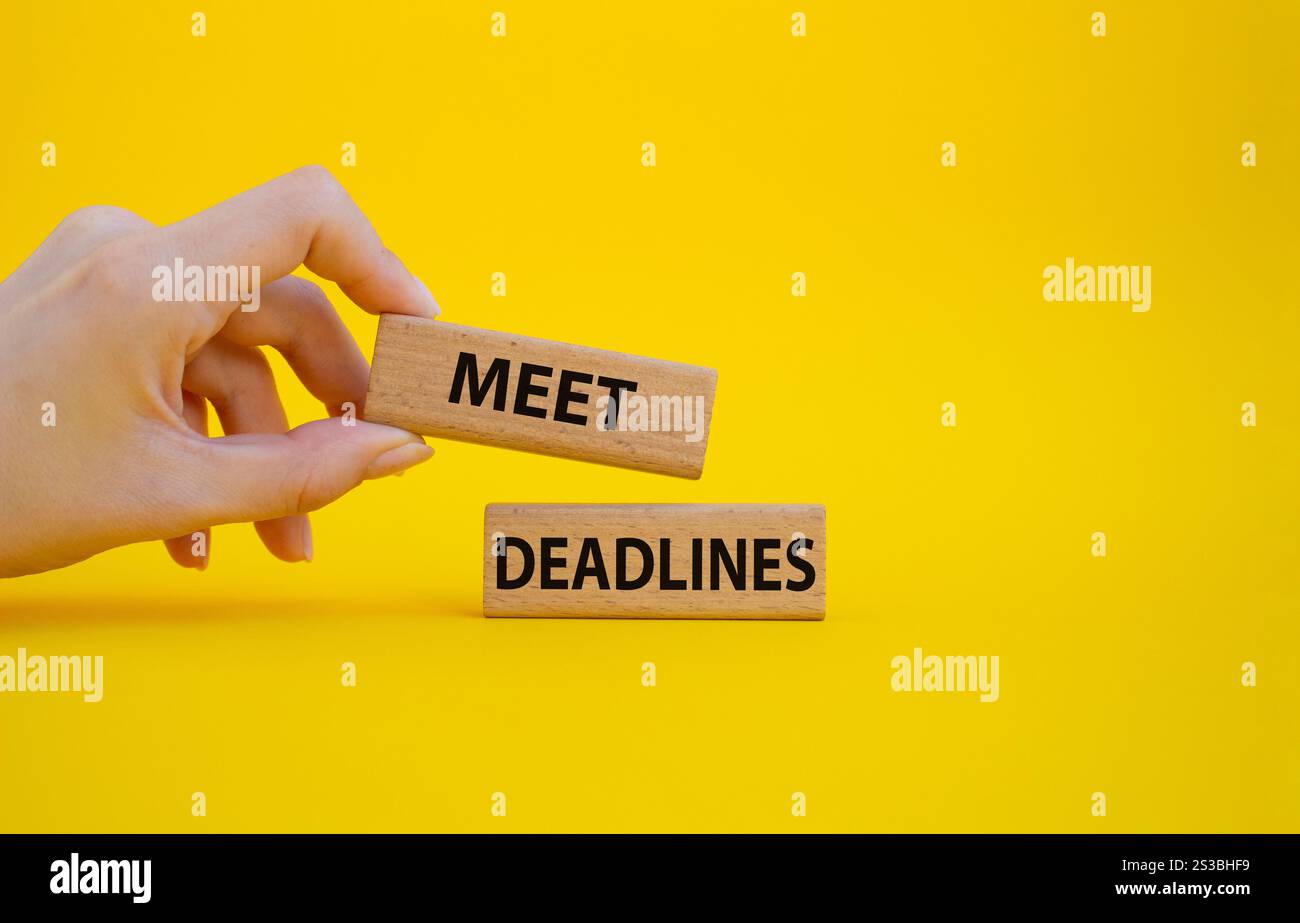 Meet Deadlines symbol. Concept word Meet Deadlines on wooden blocks ...
