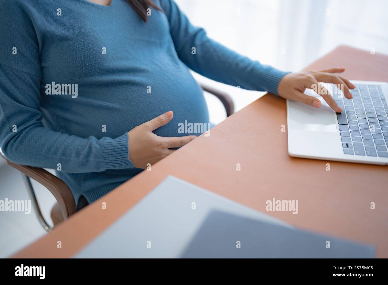 Pregnant asian woman using laptop at home pregnant businesswoman typing ...