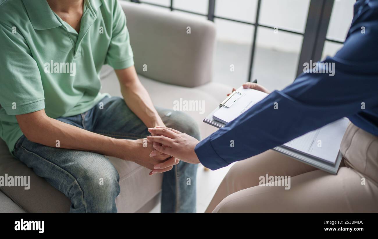 sad male sitting on sofa Patient discussing mental health issues with ...