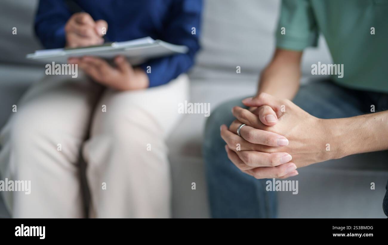 sad male sitting on sofa Patient discussing mental health issues with ...