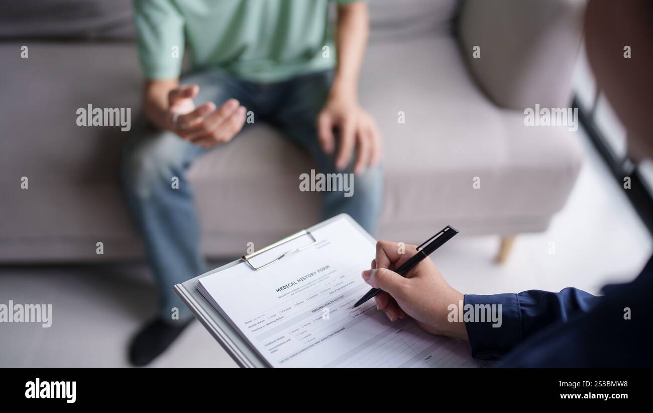 sad male sitting on sofa Patient discussing mental health issues with ...