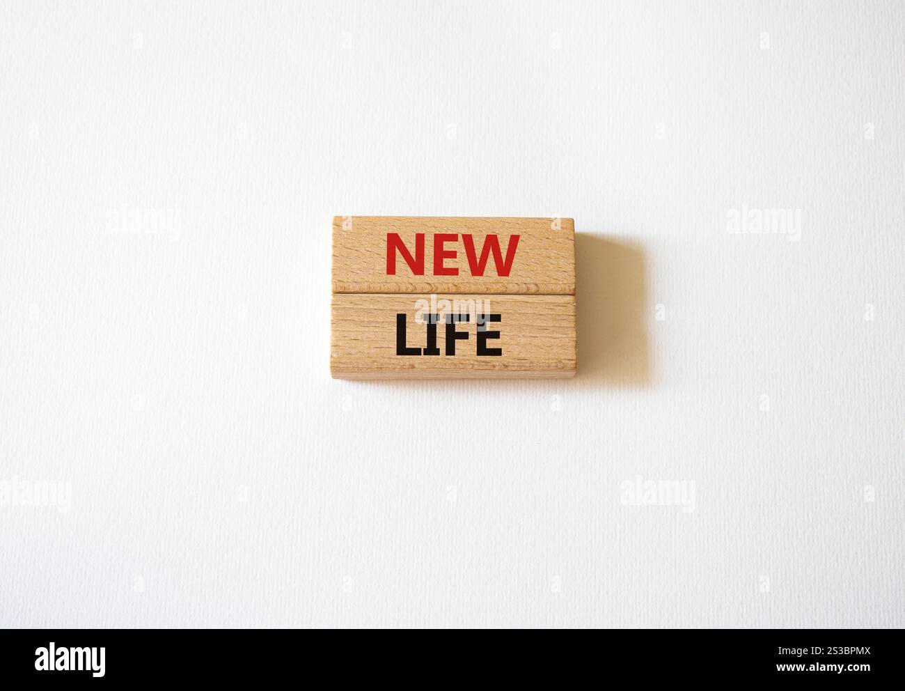 New life symbol. Wooden blocks with words New life. Beautiful white ...