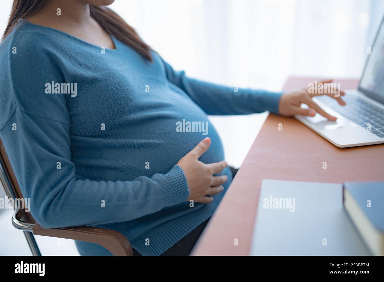 Pregnant asian woman using laptop at home pregnant businesswoman typing ...