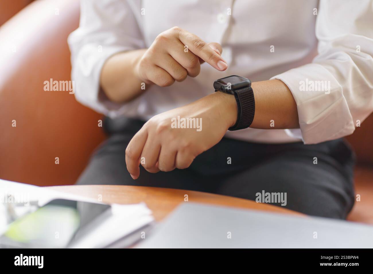 Business woman Looking at smart watch In Office online connect Gadget ...