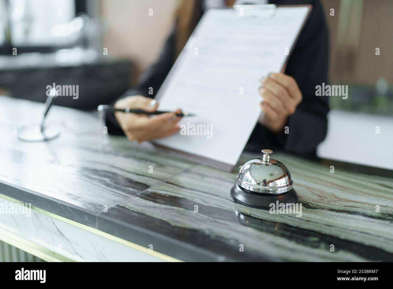 Hotel receptionist in uniforms at desk in lobby Friendly and welcome ...
