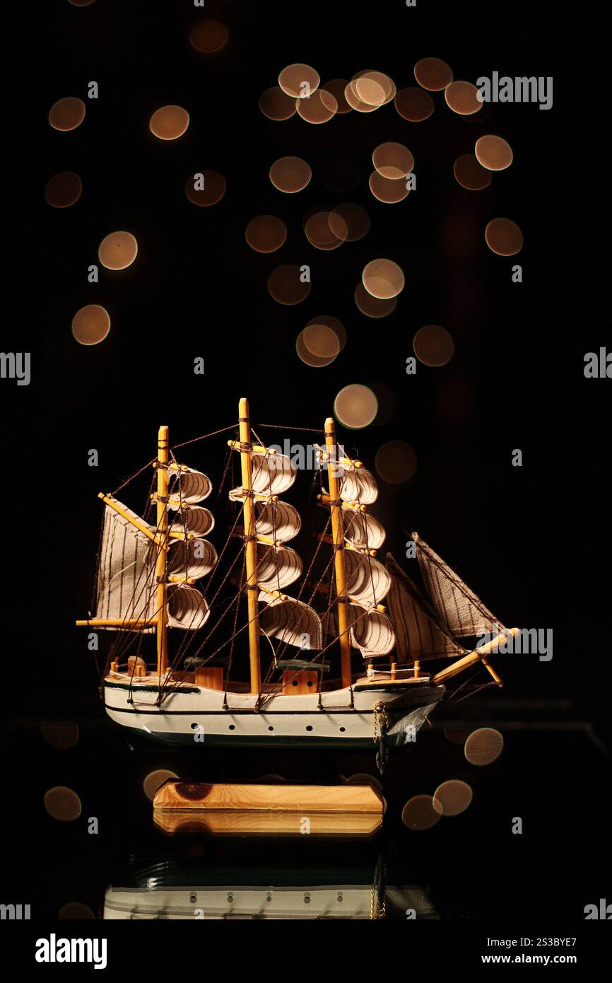Miniature sailing ship model in dark twinkling background Stock Photo ...