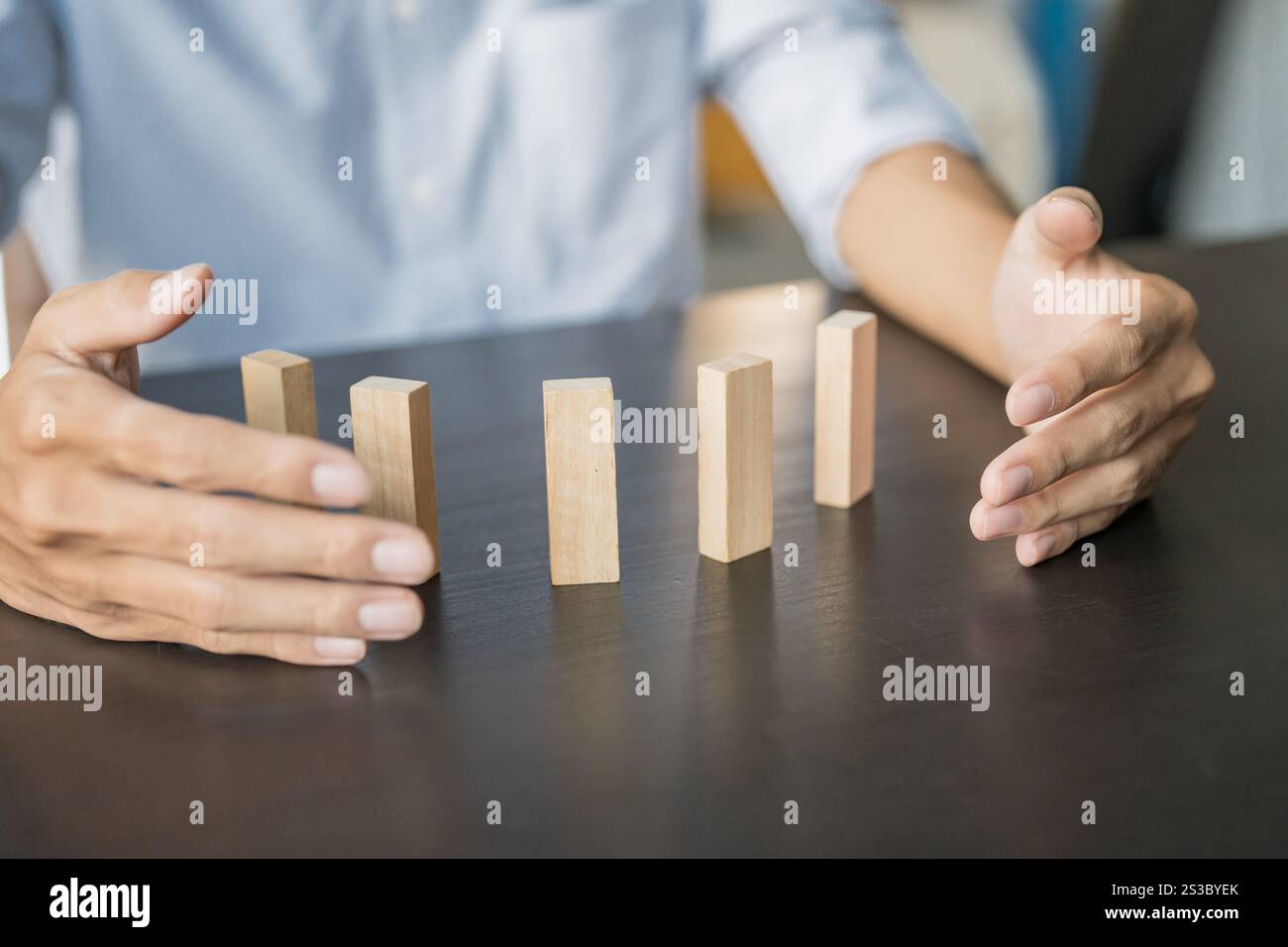 Business Planning risk and strategy hand protect wood block in ...