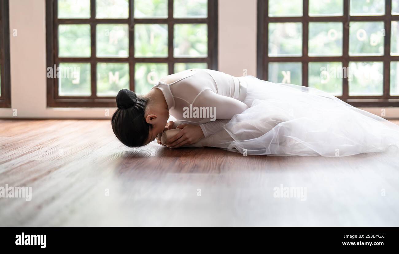 Asian girl ballet dancer gymnastic exercises in studio for body ...