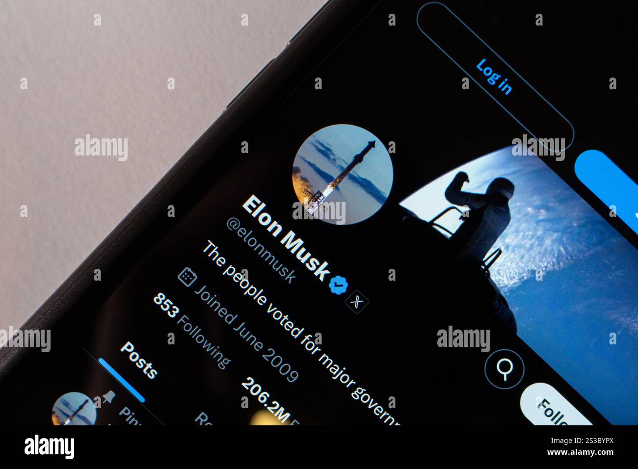 Close-up view of a smartphone screen displaying Elon Musk's verified X ...