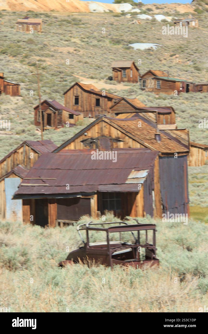 A rustic cabin is surrounded by other cabins. The cabin is old and has ...
