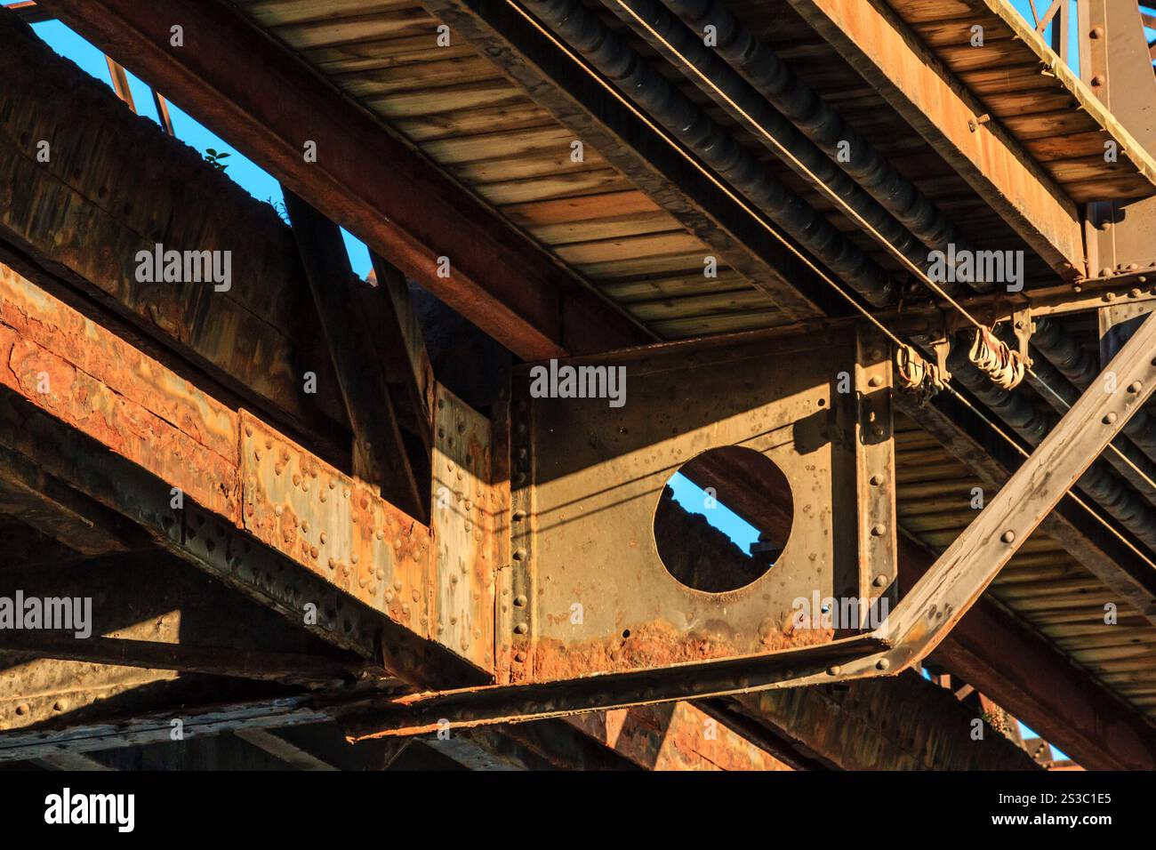 A rusted metal beam with a hole in the middle. The beam is old and worn ...