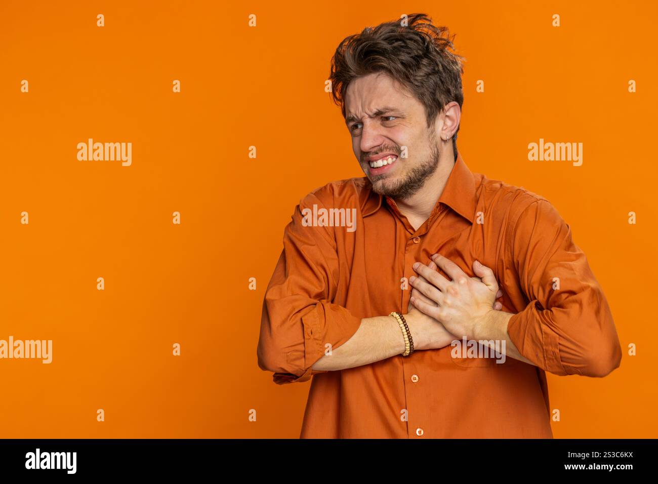 Stressed scared sick ill Caucasian man suffers from tension holding ...