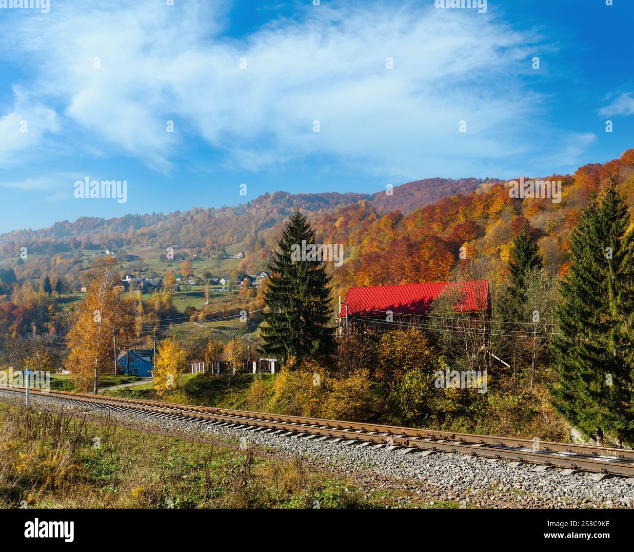 Autumn Carpathian Mountains misty landscape with village and railroad ...