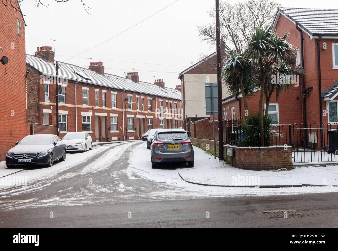 Road with snow and snow covered cars. Trafford, Manchester. Snow ...
