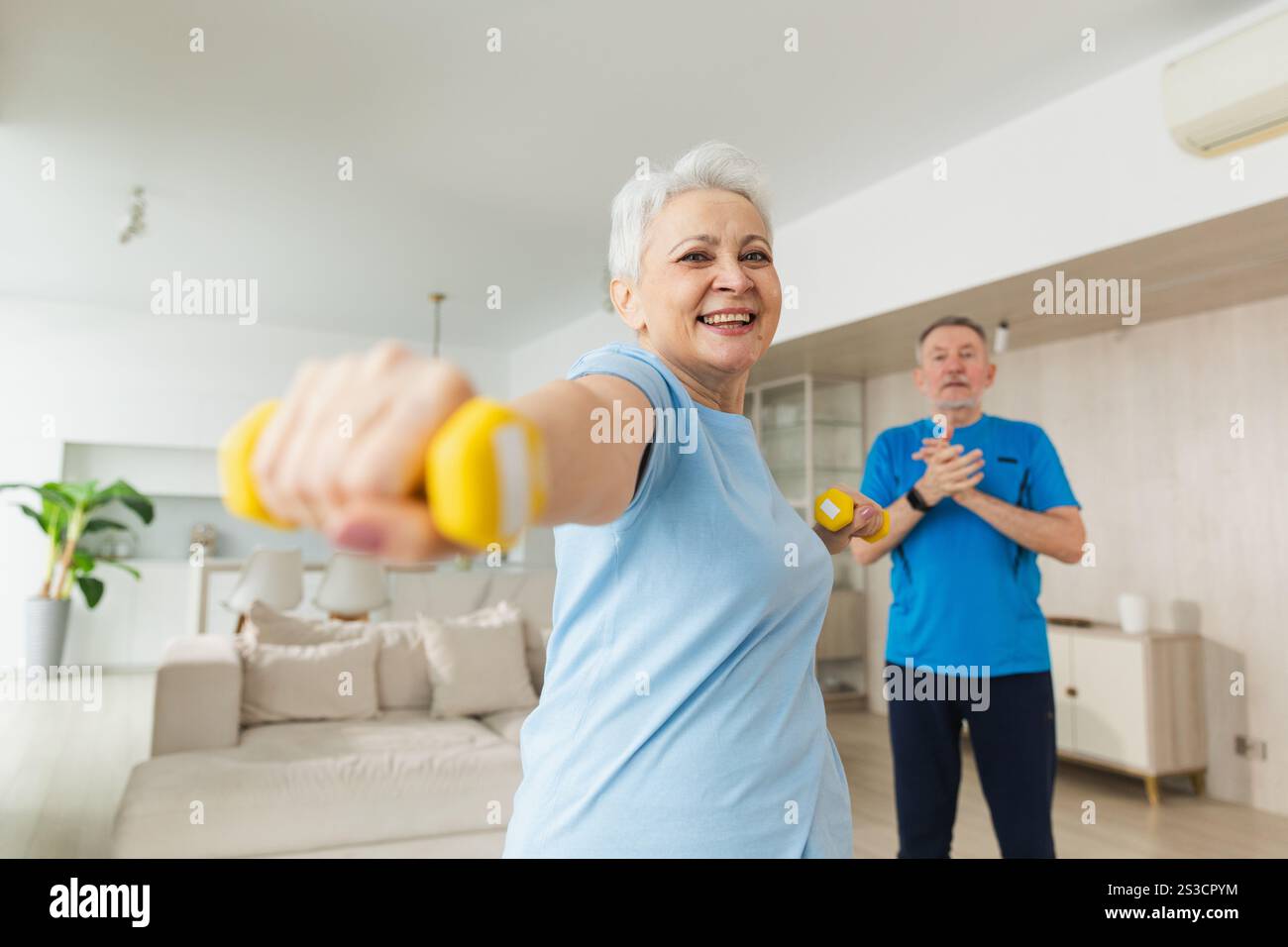 Fitness workout training. Senior woman picking up dumbbells. Old adult ...