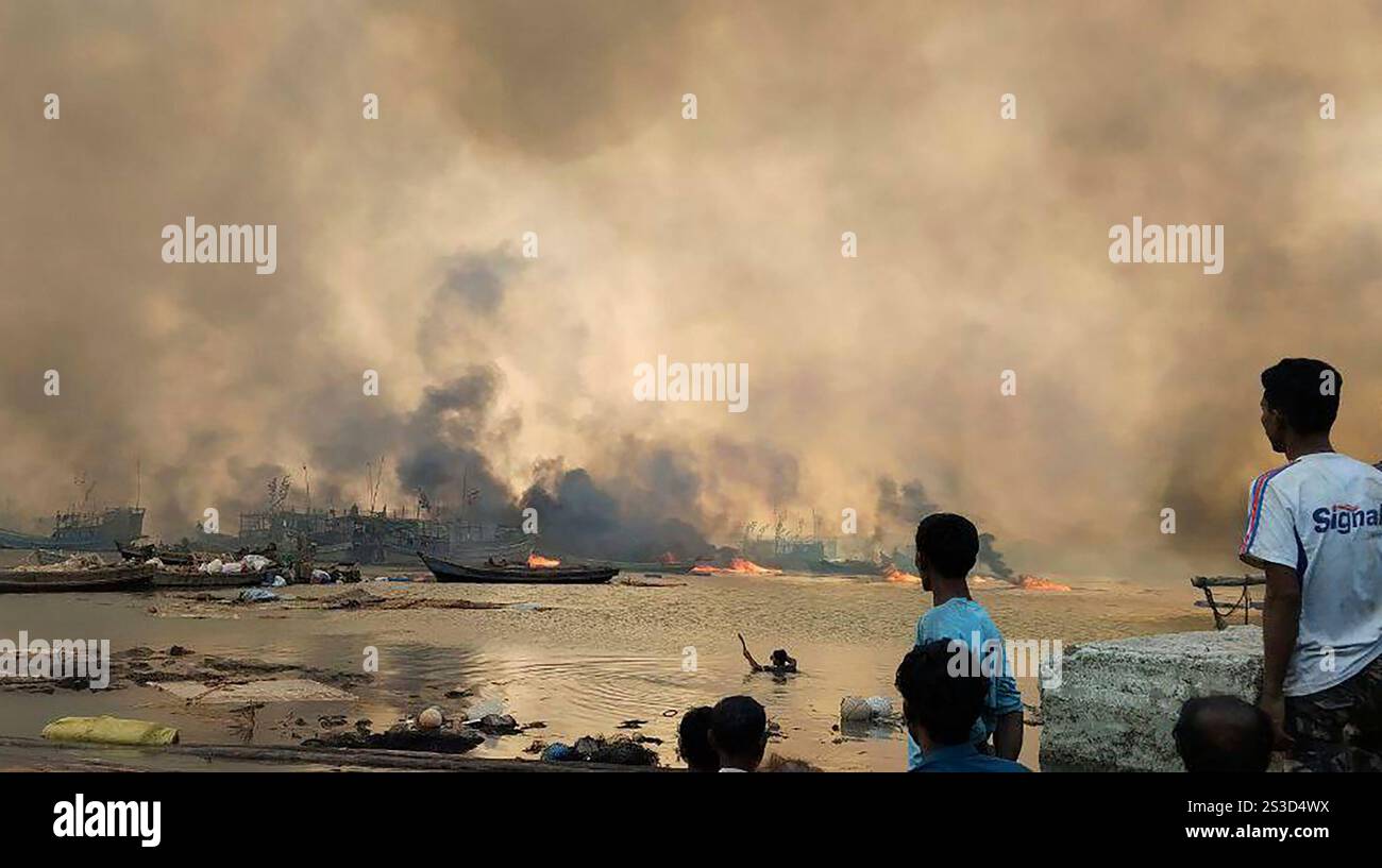 This handout photo provided by the Arakan Army shows people looking at ...