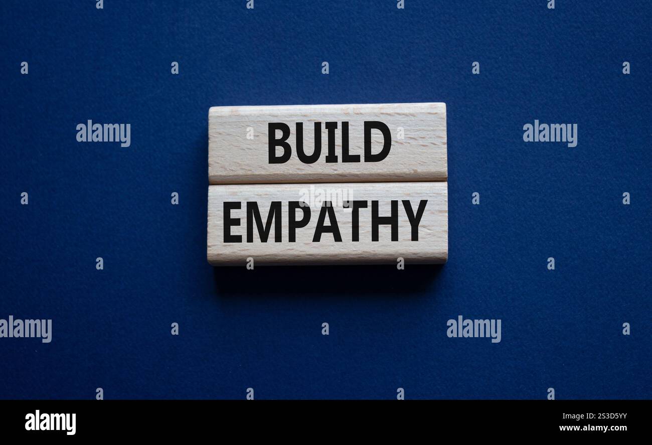 Build empathy symbol. Wooden blocks with words Build empathy. Beautiful ...