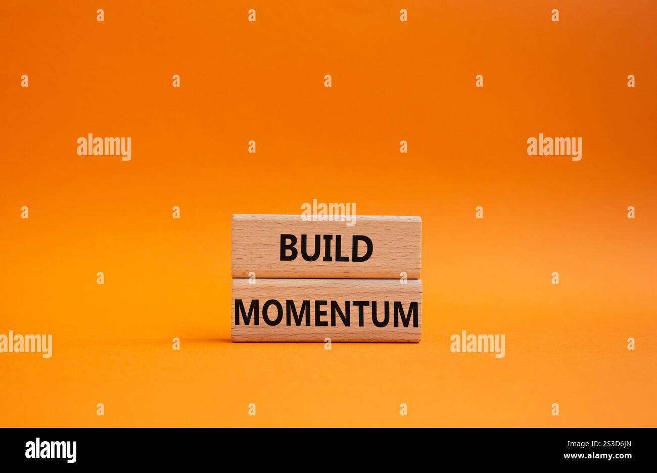 Build momentum symbol. Wooden blocks with words Build momentum ...