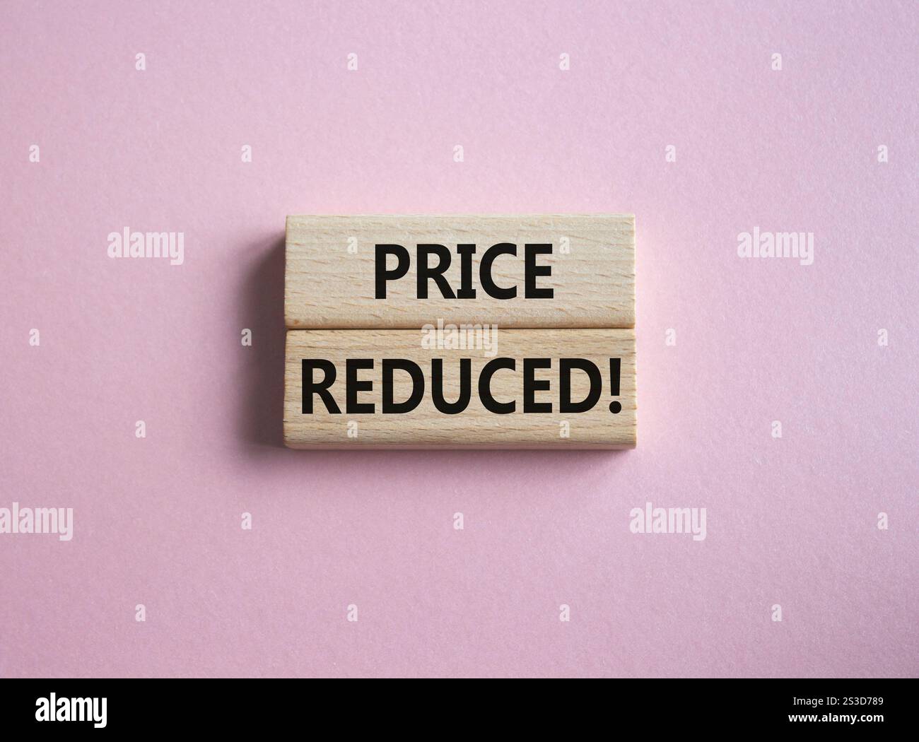 Price reduced symbol. Concept word Price reduced on wooden blocks ...