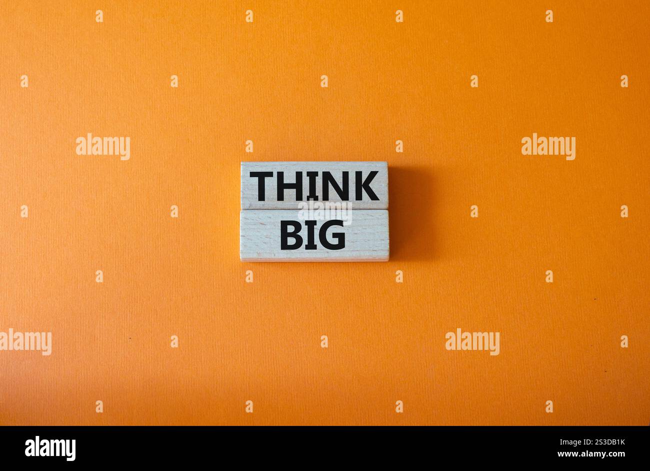 Think big symbol. Wooden blocks with words Think big. Beautiful orange ...