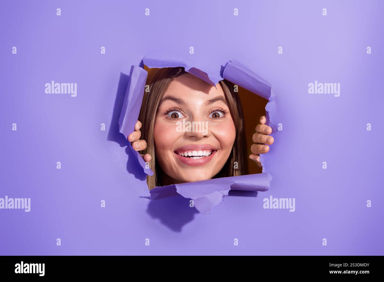 Photo portrait of pretty young girl crazy excited face peek tear violet ...