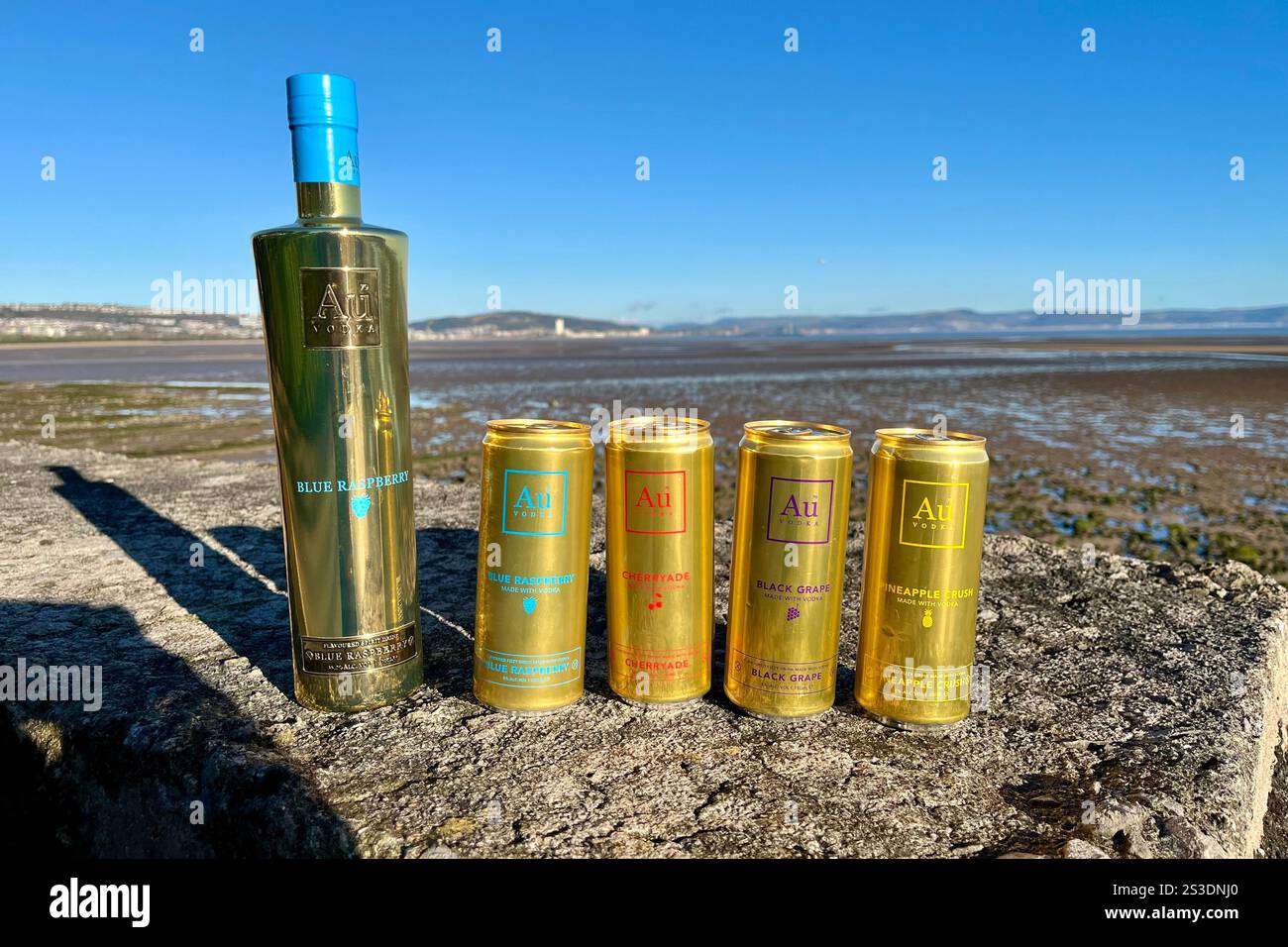 A 70cl Au Vodka Blue Raspberry bottle and four Au Vodka Pre-Mixed Cans ...