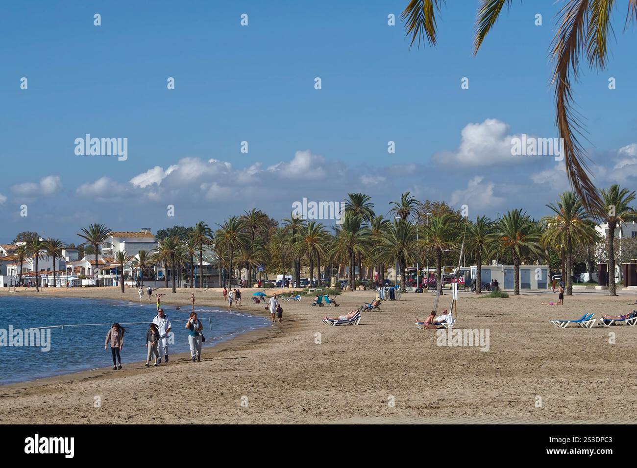 people walking and sunbathing on the beach at Roses,Costa Brava ...