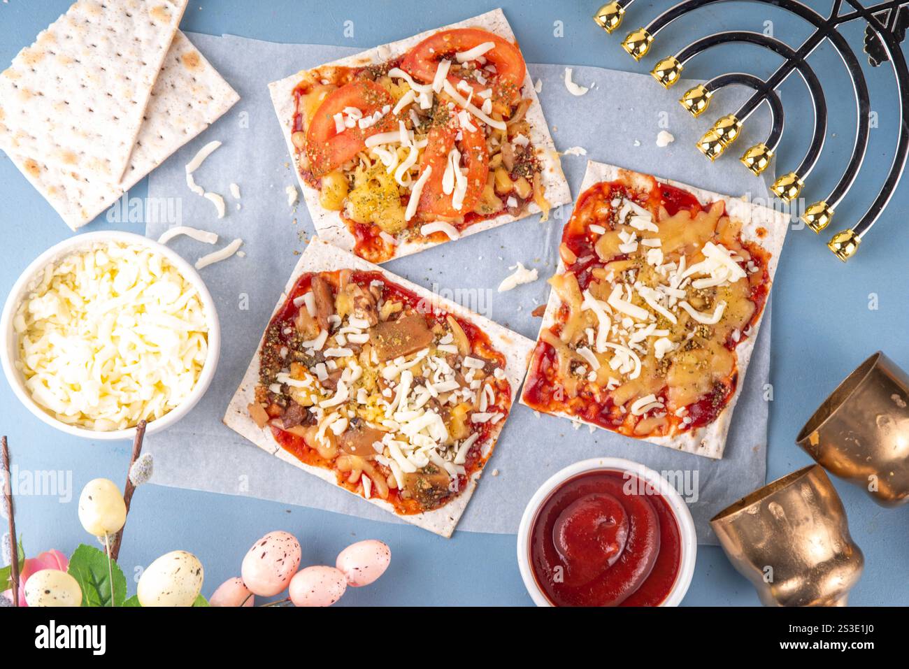 Matzah Pizza on light blue background with ingredients, cheese, tomato ...