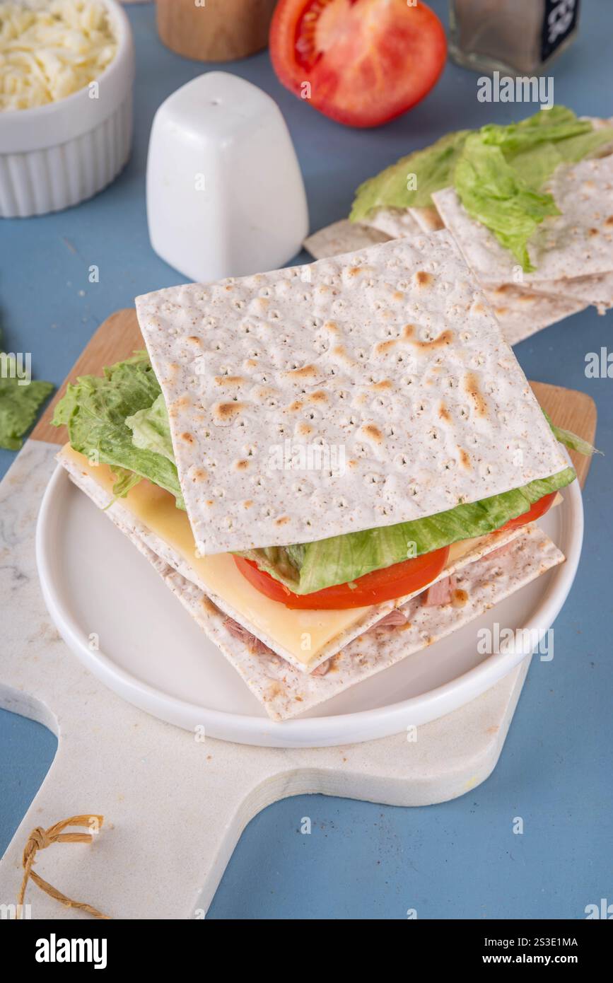 Tasty matzah sandwich with tuna, cheese, lettuce and vegetables. Viral ...
