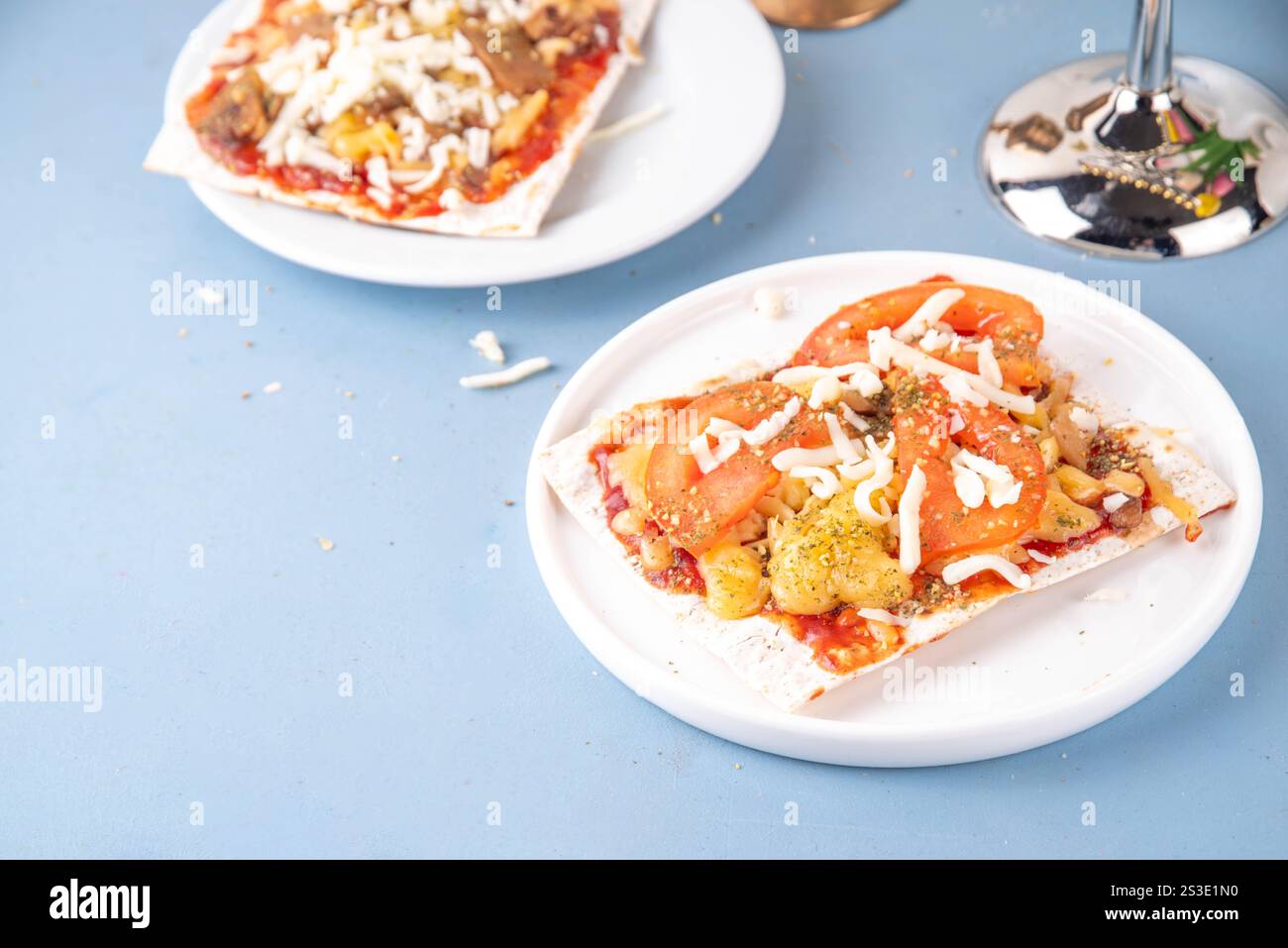 Matzah Pizza on light blue background with ingredients, cheese, tomato ...