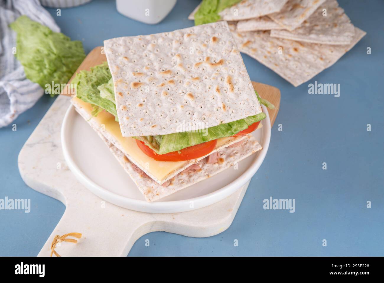 Tasty matzah sandwich with tuna, cheese, lettuce and vegetables. Viral ...