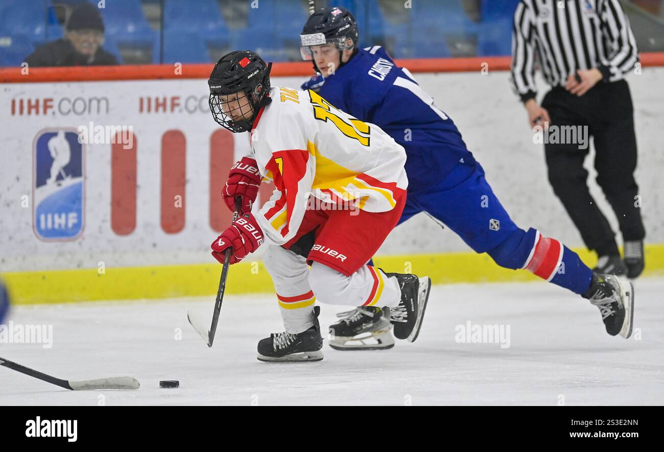 Boyu Tian plays the puck during the 2025 Ice Hockey U20 World Championship Division II Group A ...