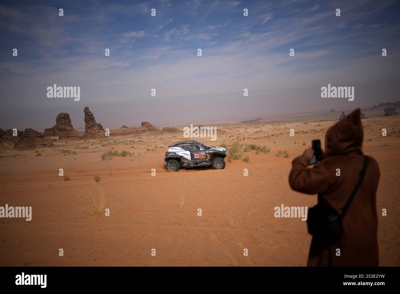 A man takes a photo of Driver Lionel Baud and co-driver Lucie Baud ...