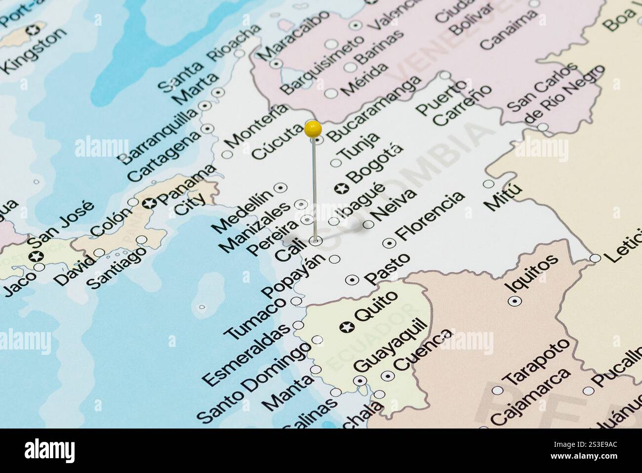Macro photo of a yellow pin needle into Cali city of Colombia political ...