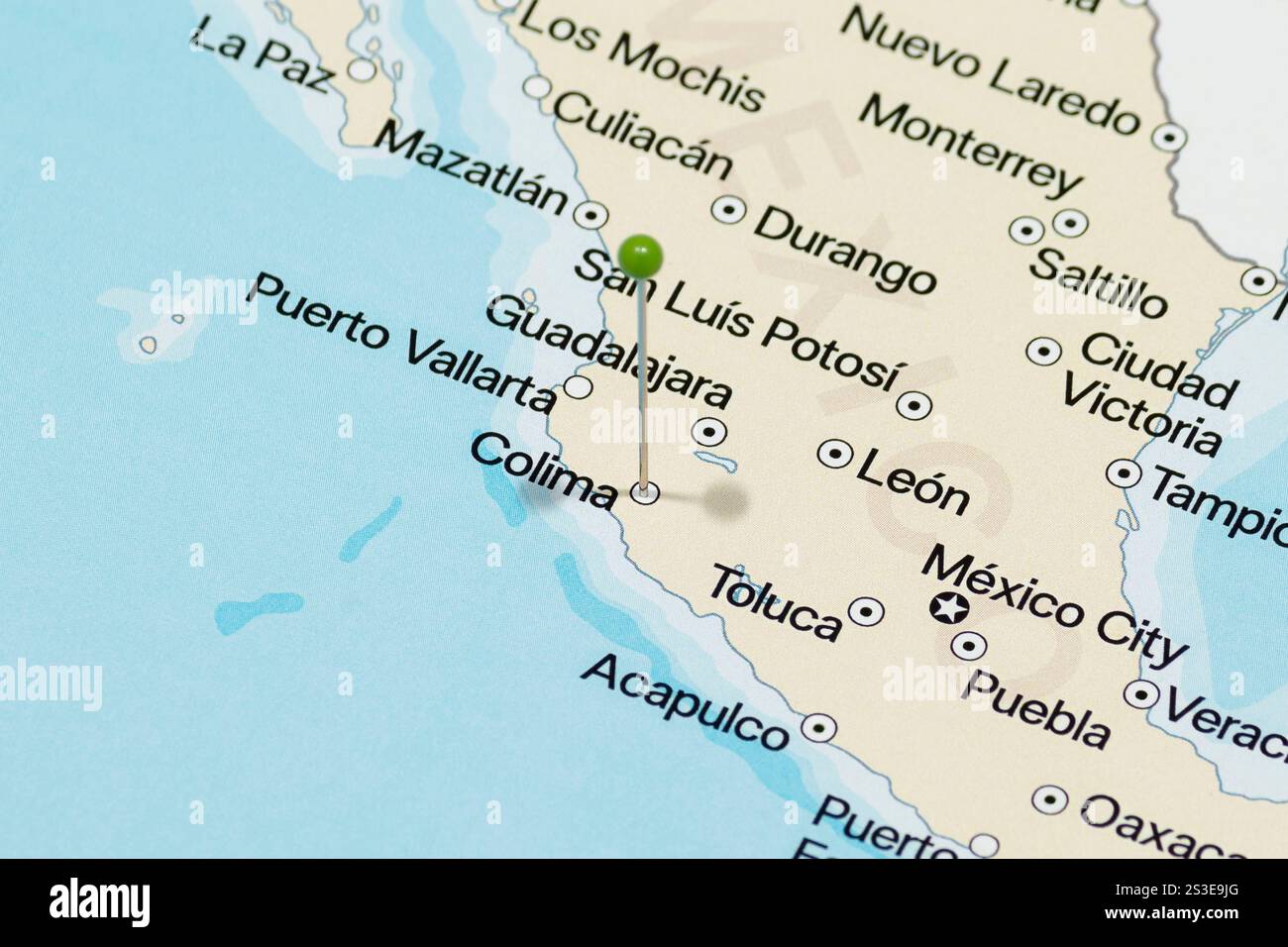 Macro photo of a green pin needle into Colima of Mexico city political ...