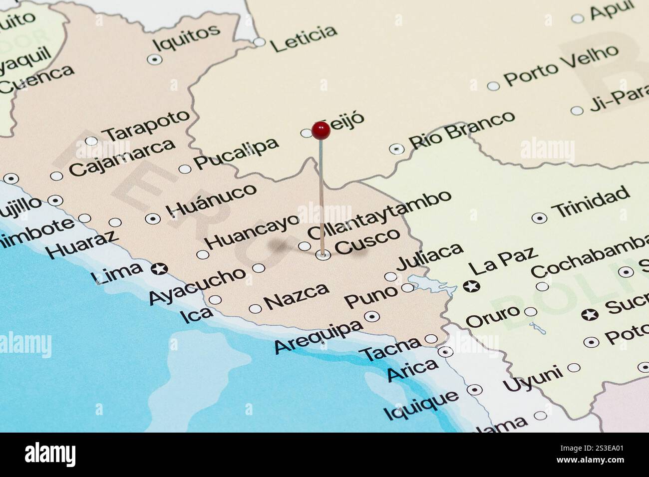 Macro photo of a white pin needle into Cusco city of Peru political map ...
