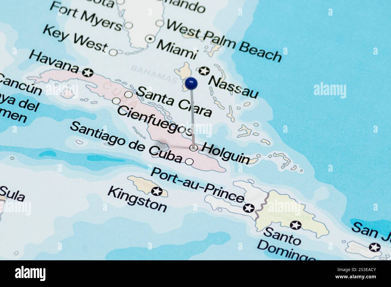 Macro photo of blue pin needle into Holguin city of Cuba political map ...