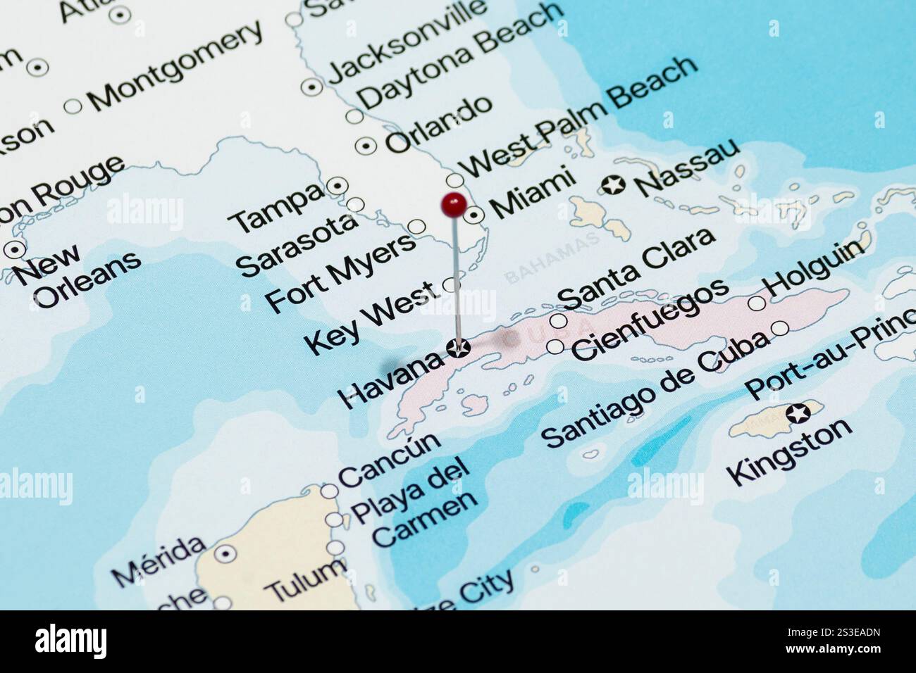 Macro photo of red pin needle into Havana city of Cuba political map ...