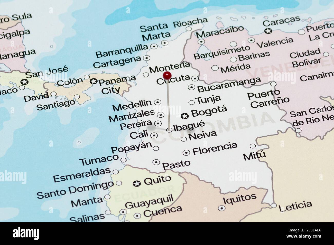 Macro photo of a red pin needle into Ibague city of Colombia political ...