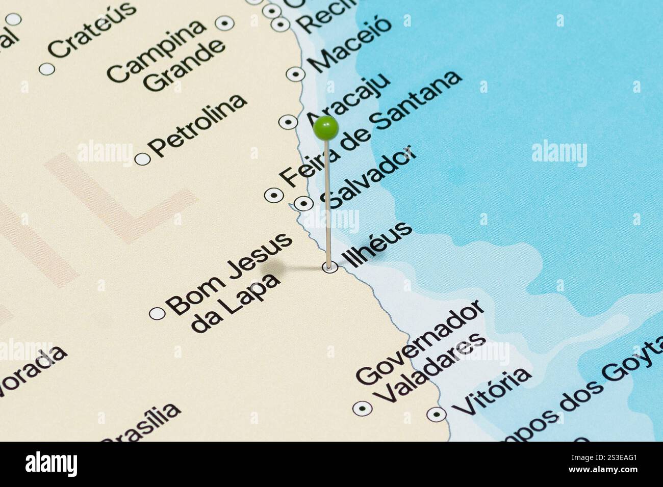 Macro photo of a green pin needle into Ilheus city of Brazil political ...