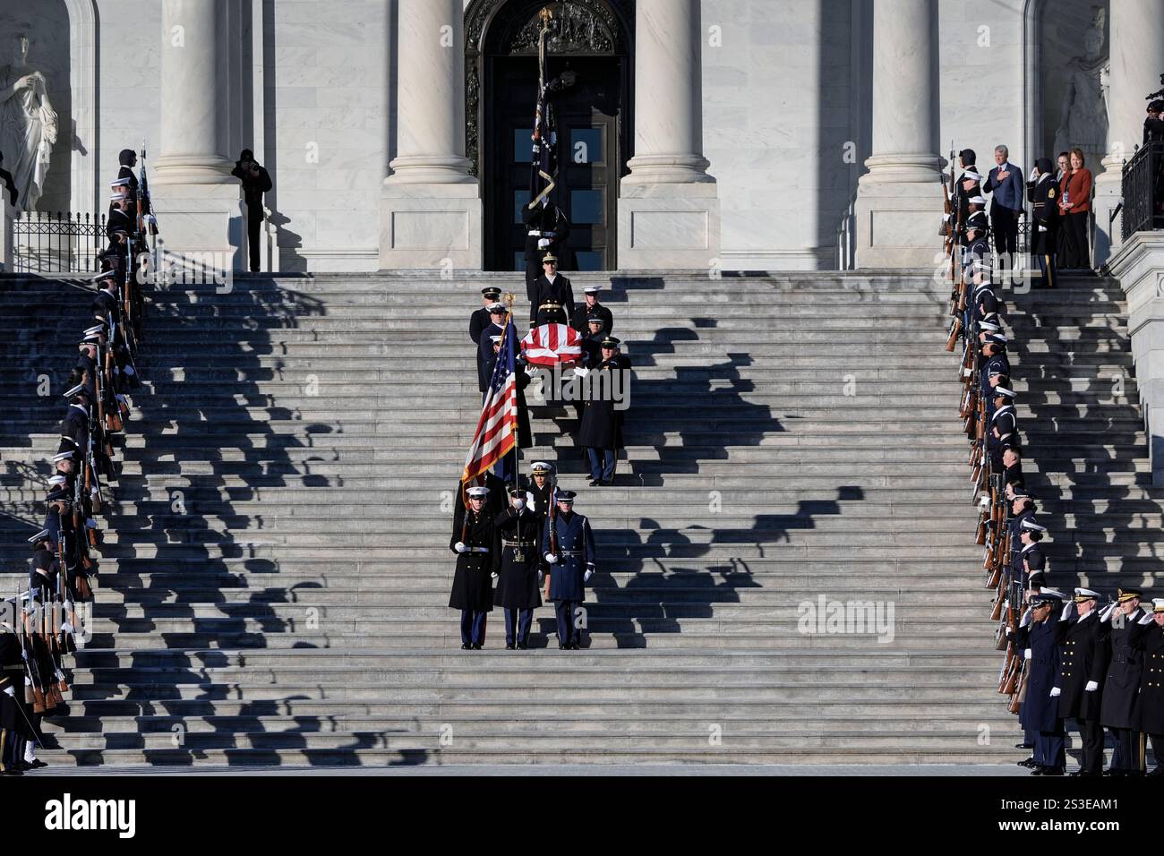 The flag-draped casket of former President Jimmy Carter is carried from ...