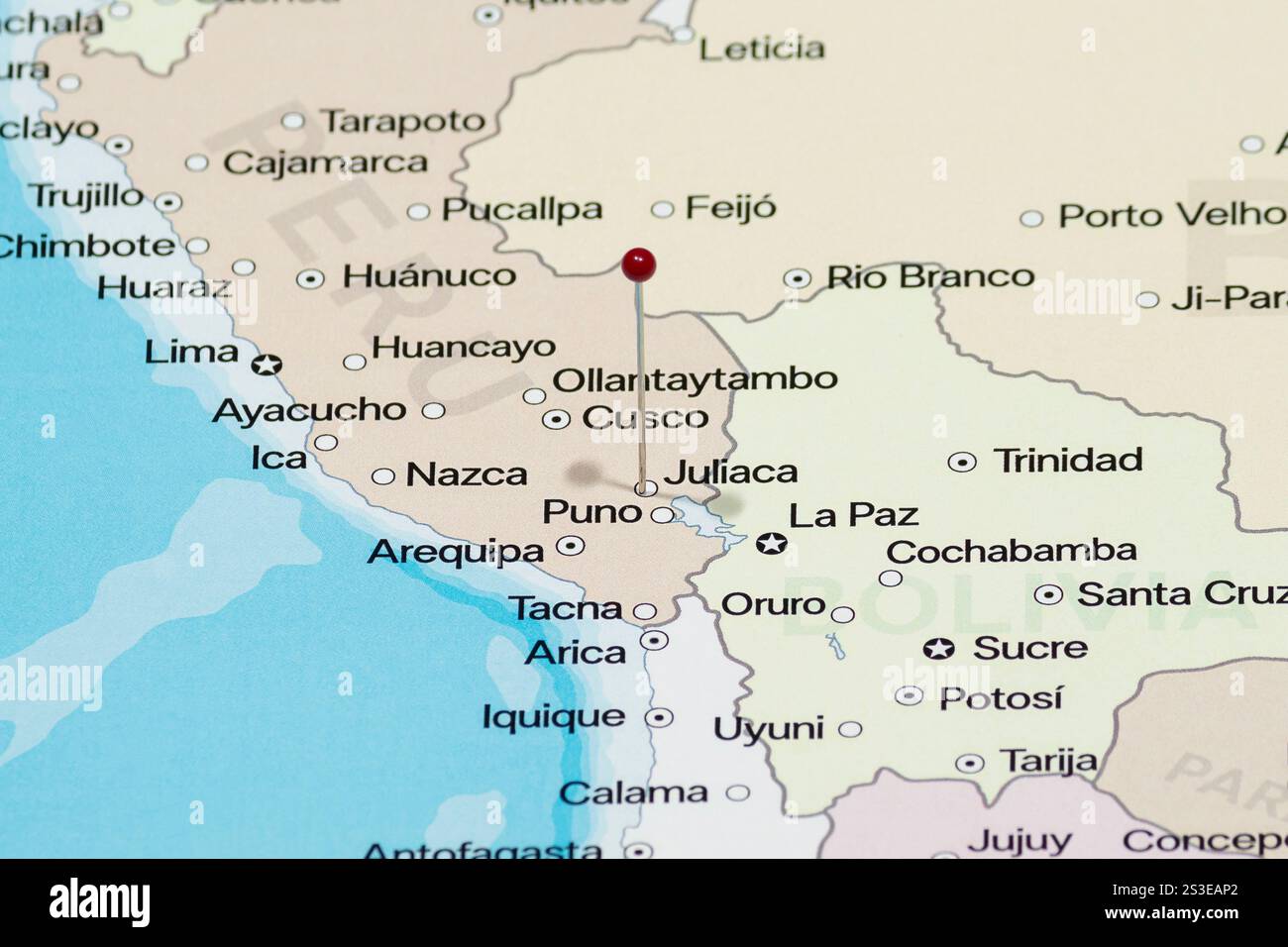 Macro photo of a red pin needle into Juliaca city of Peru political map ...