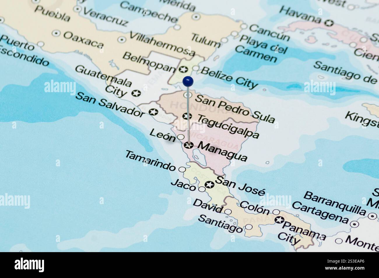 Macro photo of a blue pin needle into Managua city of Nicaragua ...