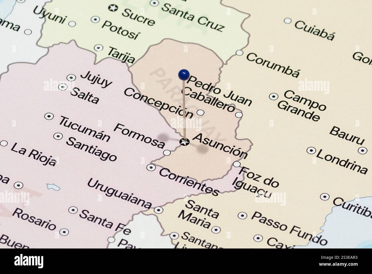 Macro photo of a blue pin needle into Asuncion city of Paraguay ...