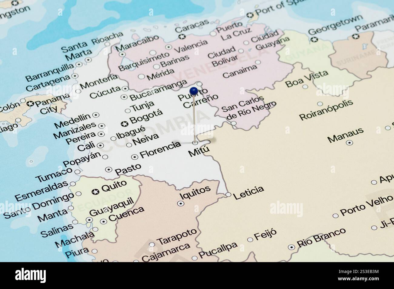 Macro photo of a blue pin needle into Mitu city of Colombia political ...