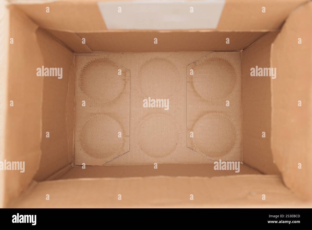 An empty cardboard box that comes with circular inserts designed for ...